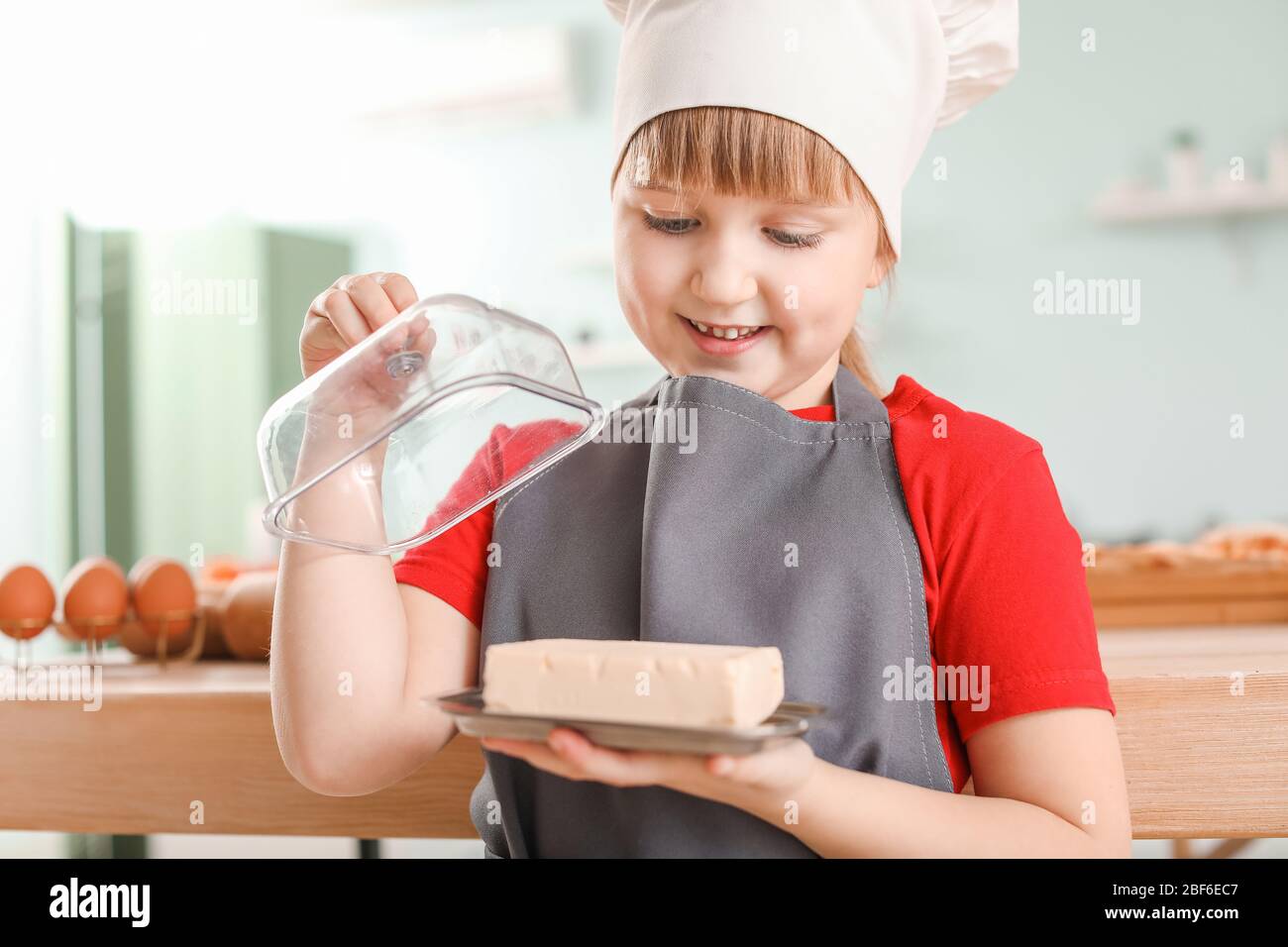 Cute little chef in kitchen Stock Photo - Alamy