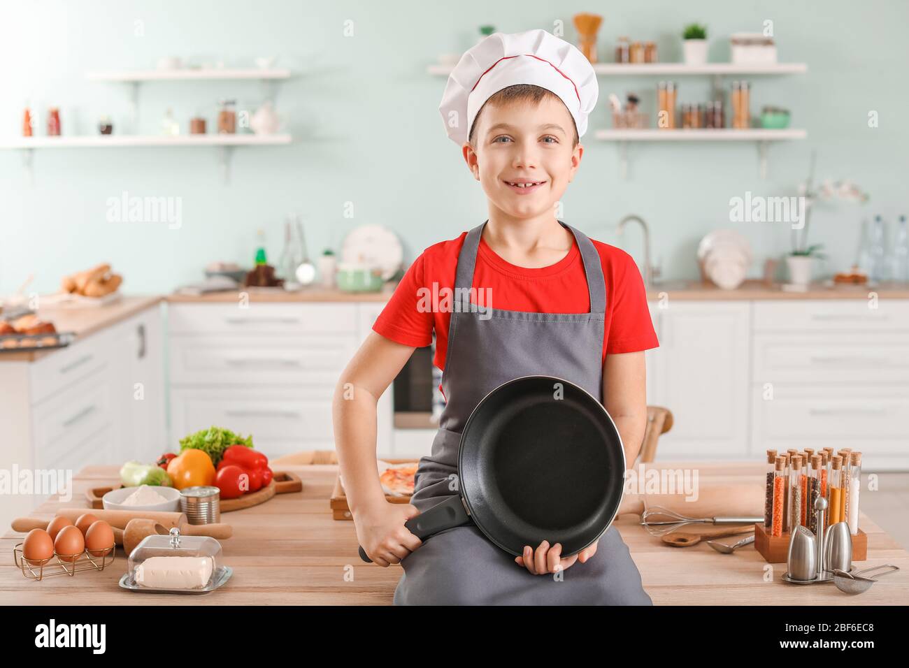 Cute little chef in kitchen Stock Photo - Alamy