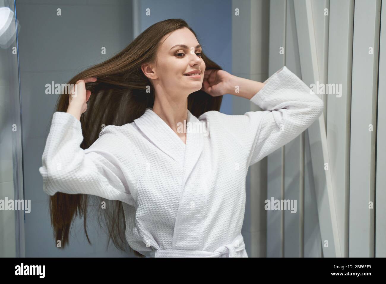 Contented cute girl standing in the bathroom Stock Photo - Alamy