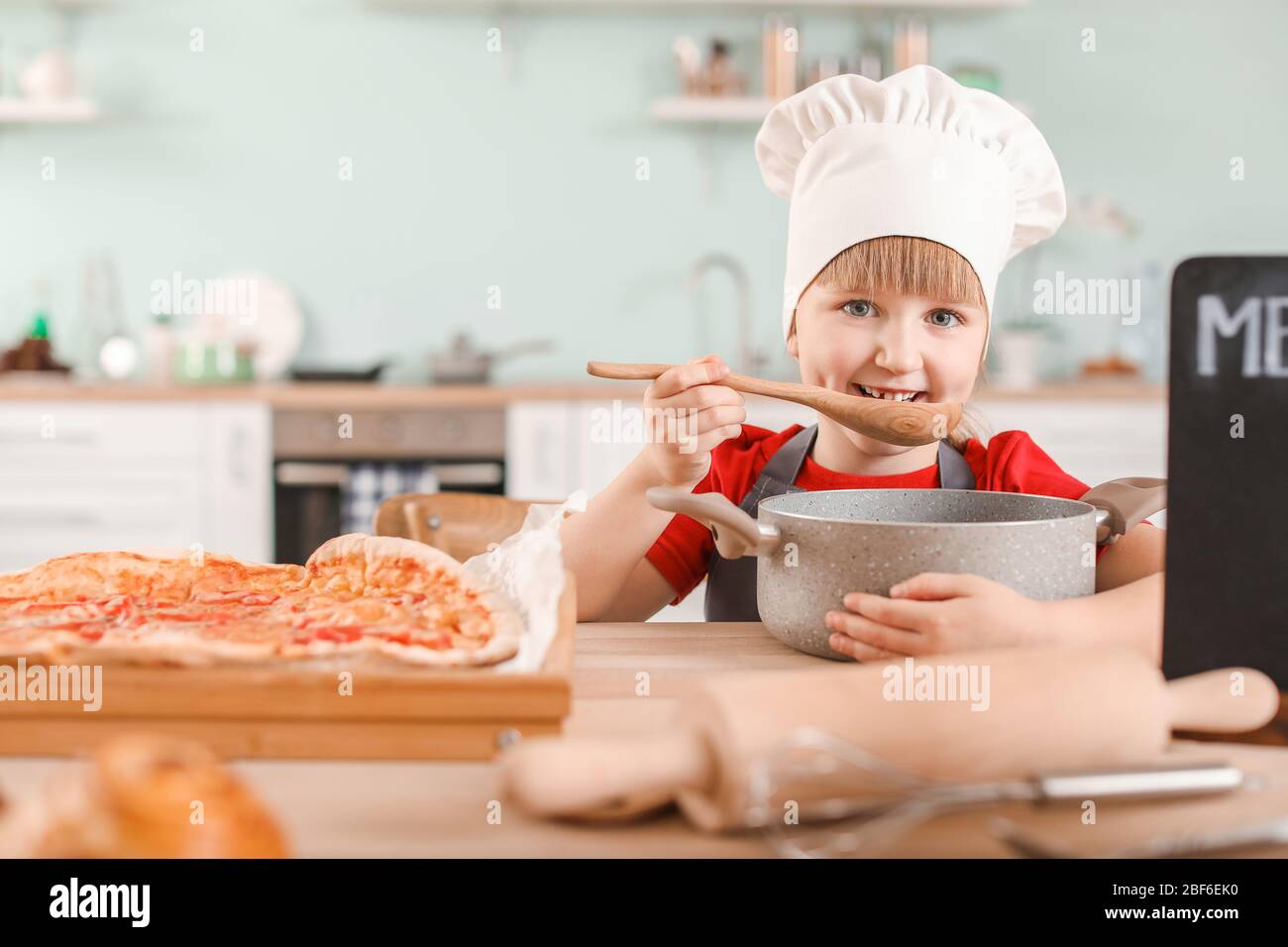 Cute little chef cooking in kitchen Stock Photo - Alamy