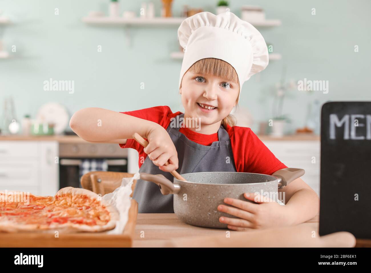 Cute little chef cooking in kitchen Stock Photo - Alamy