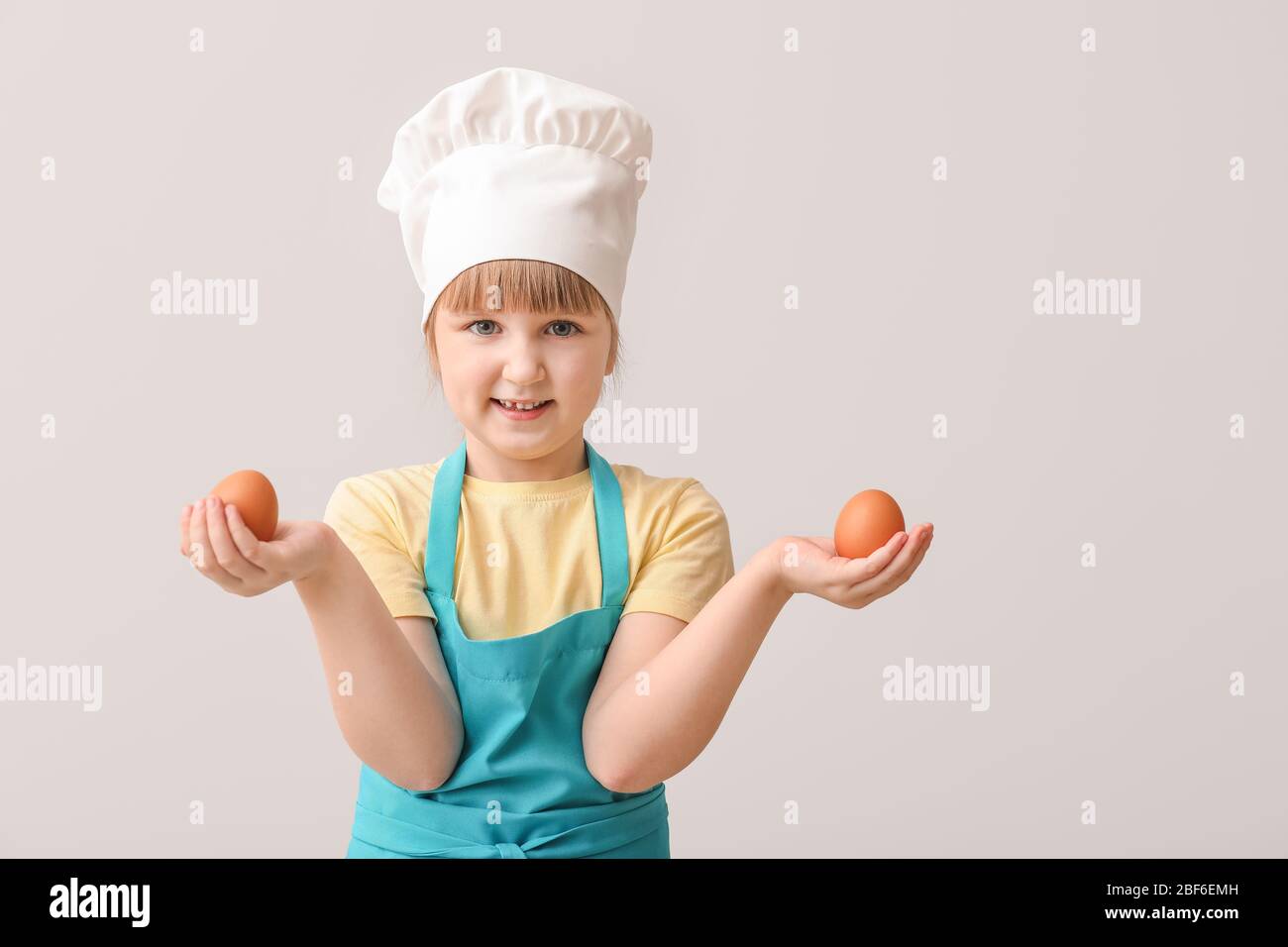 Cute little chef on light background Stock Photo - Alamy