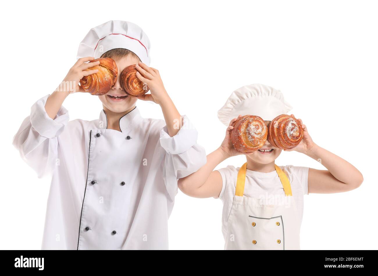 Cute little chefs with pastry on white background Stock Photo - Alamy