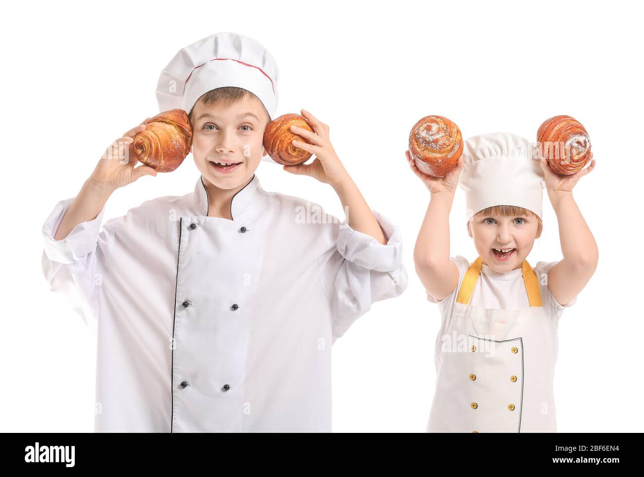 Cute little chefs with pastry on white background Stock Photo - Alamy