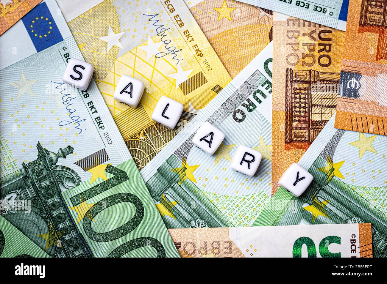 Beaded inscription "salary" and euro notes Stock Photo - Alamy