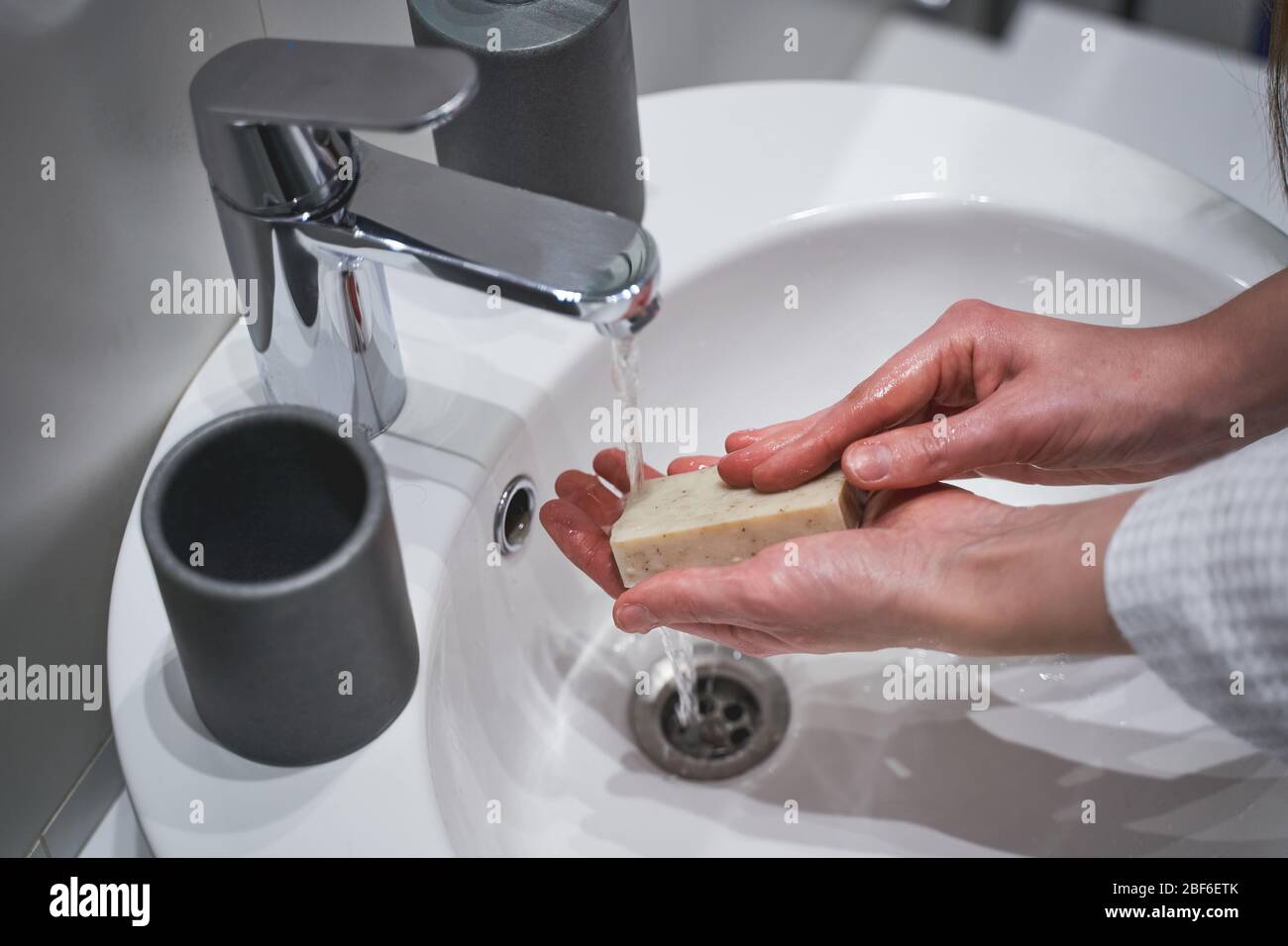 Girl using a soap bar for hand hygiene Stock Photo - Alamy