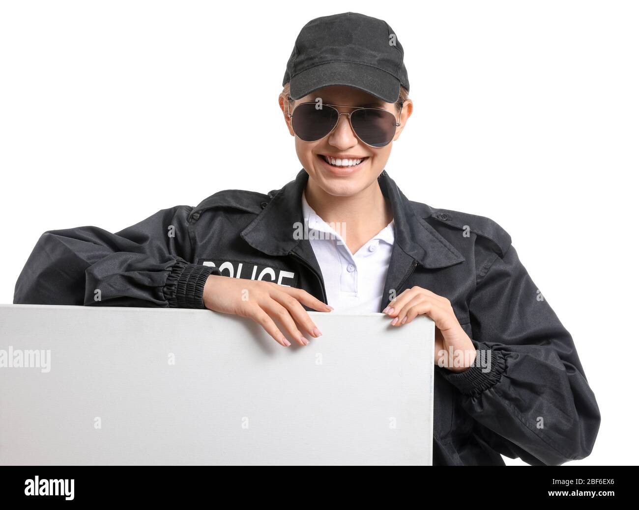 Female police officer with blank poster on white background Stock Photo ...