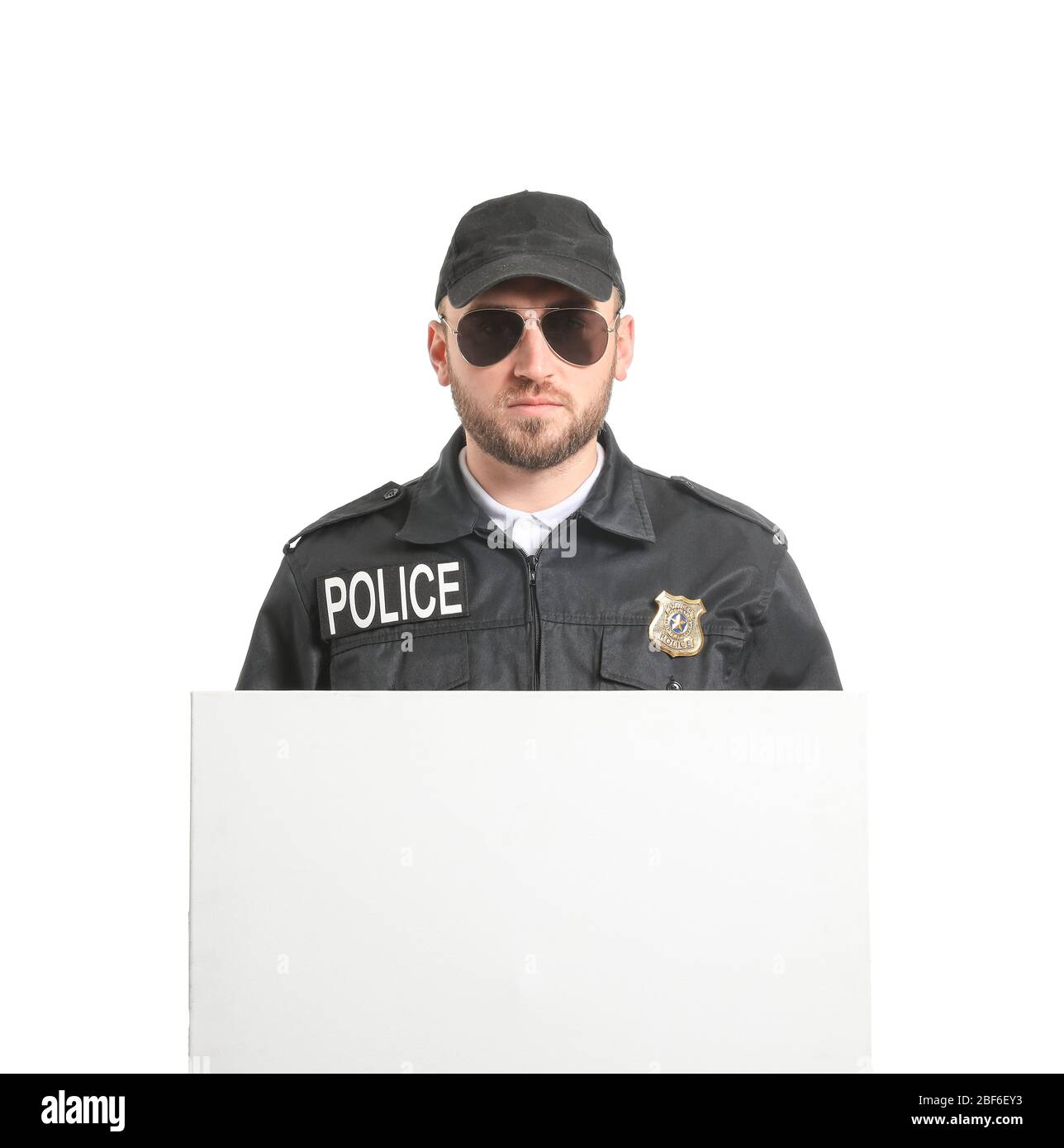 Male police officer with blank poster on white background Stock Photo ...