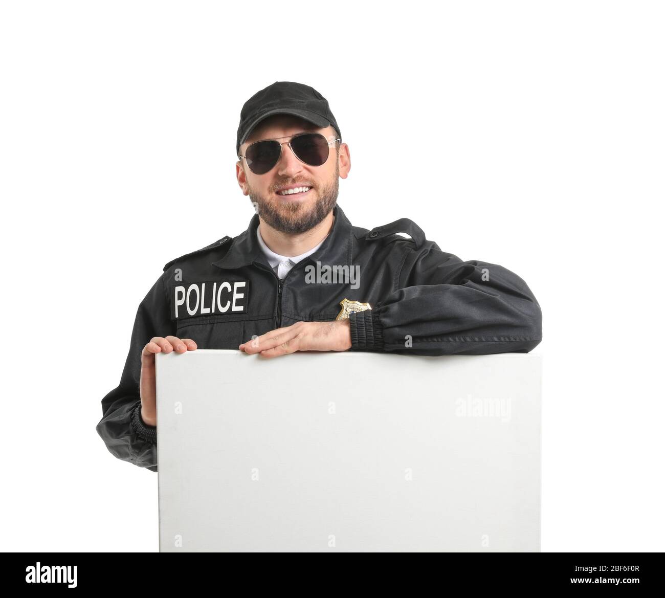 Male police officer with blank poster on white background Stock Photo ...