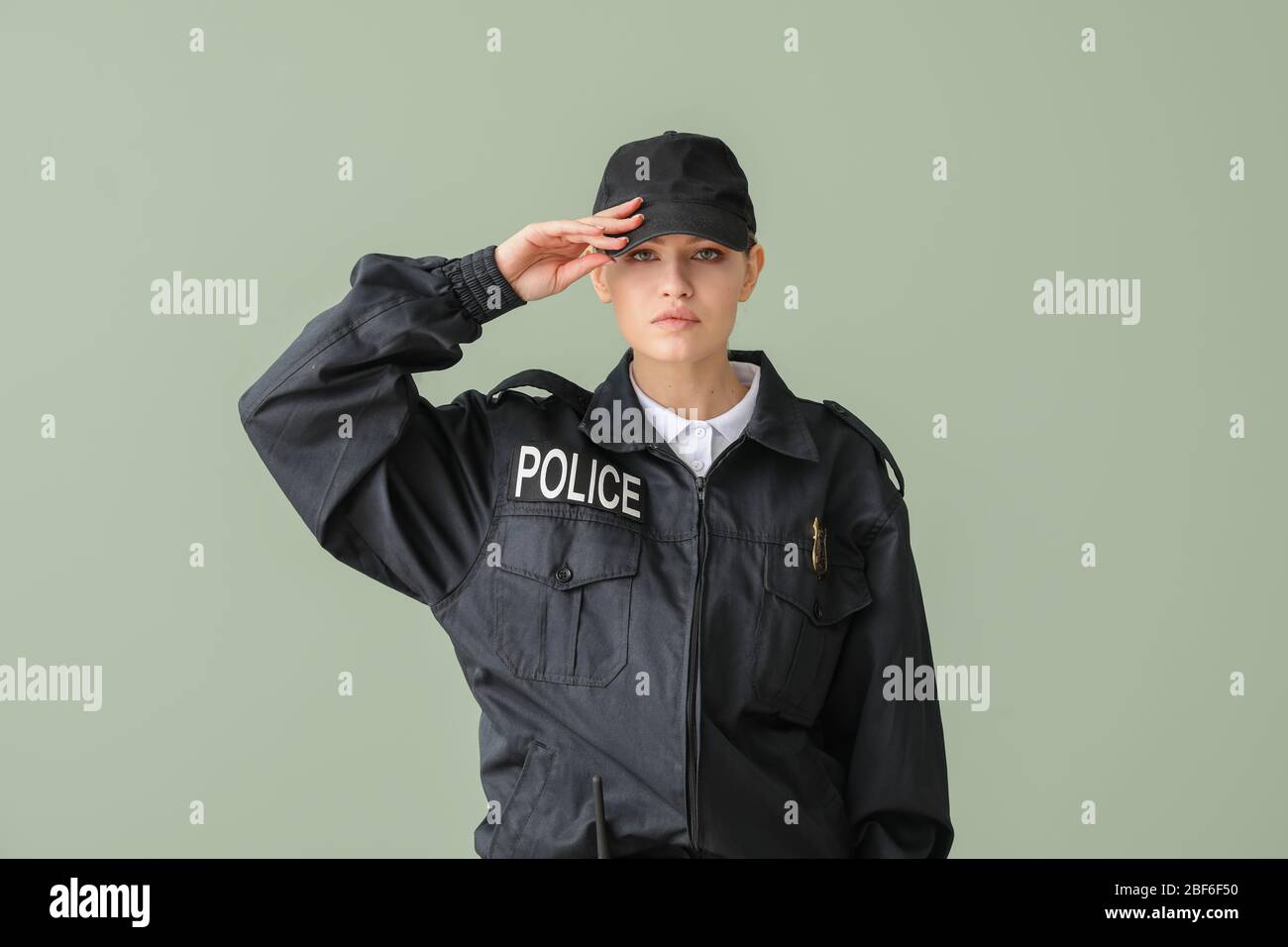 Female police officer on color background Stock Photo - Alamy