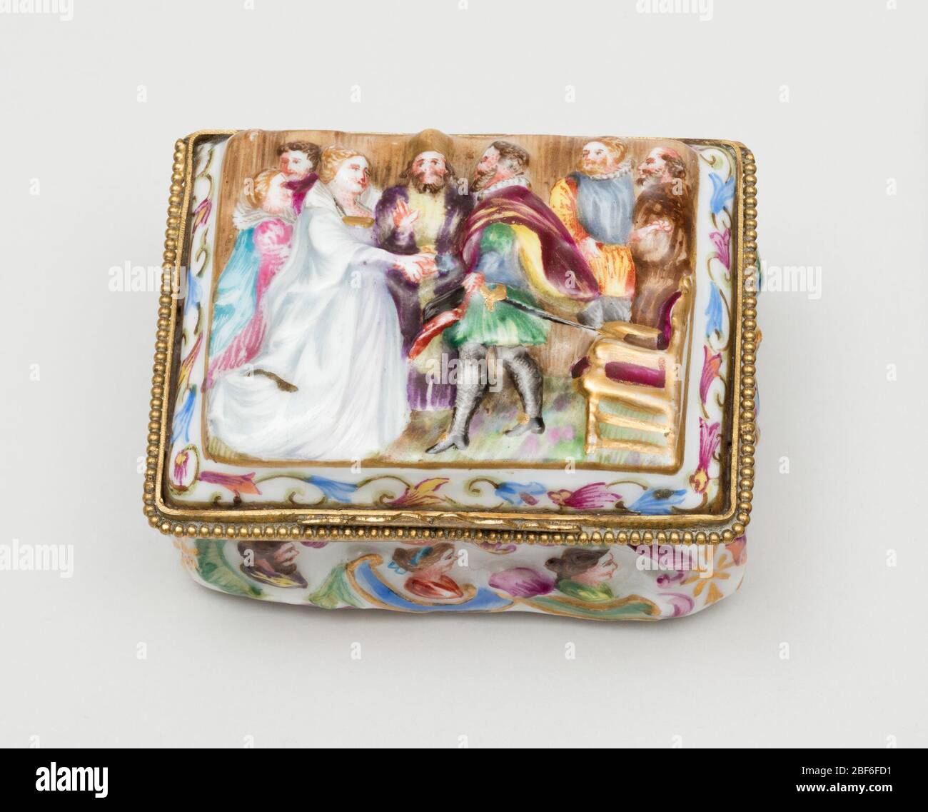 Snuff box. Box, raised and colored decoration, heads & scrolls. Lid ...