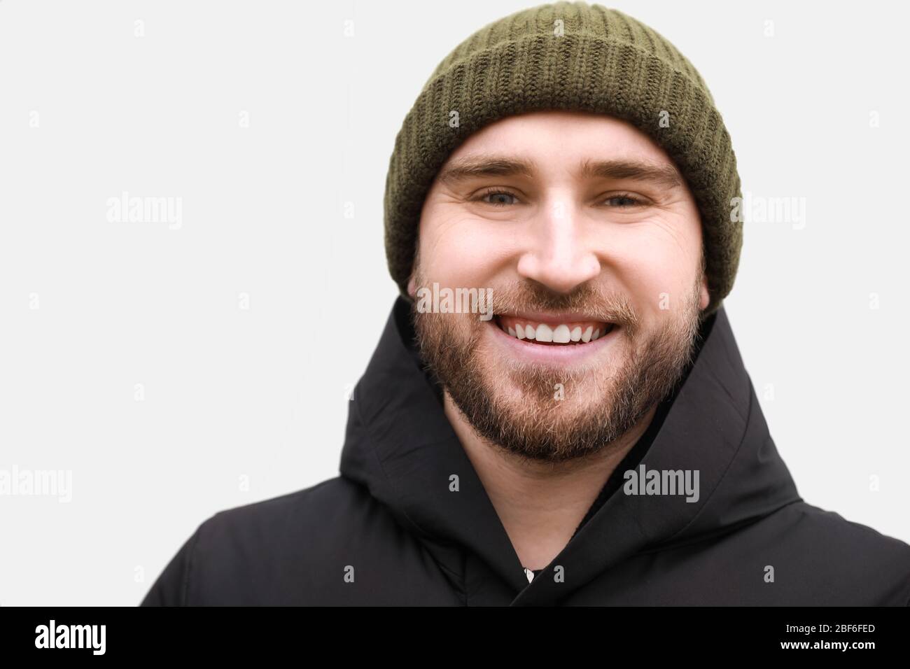 Happy smiling young man on light background Stock Photo - Alamy
