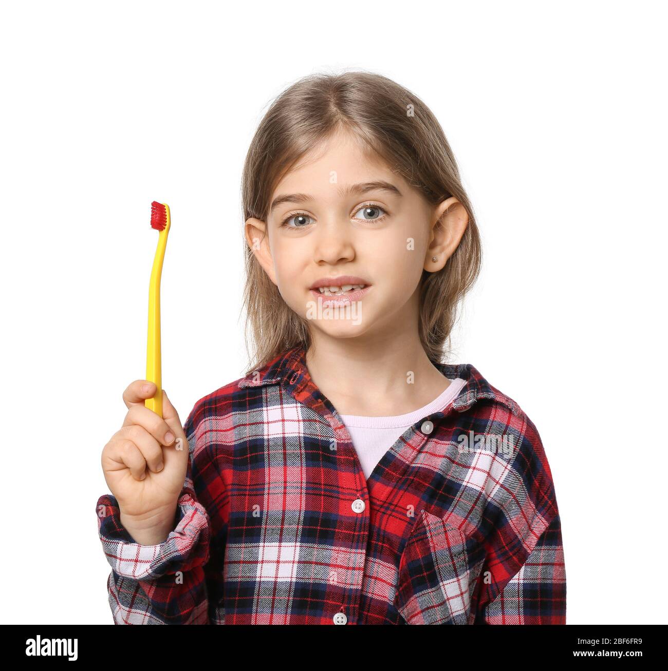 Cute little girl with toothbrush on white background Stock Photo - Alamy