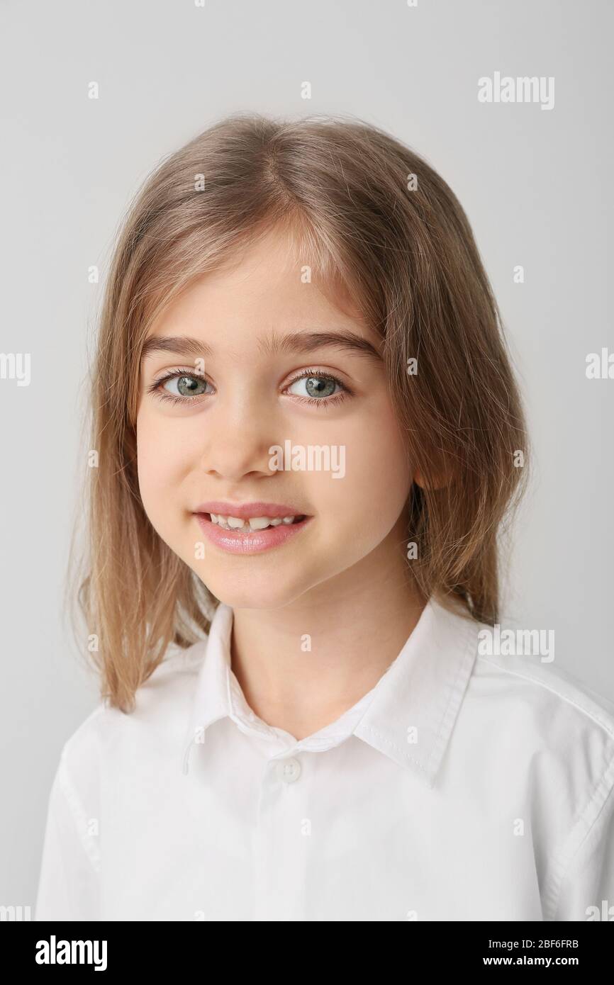 Happy little girl with healthy teeth on light background Stock Photo ...