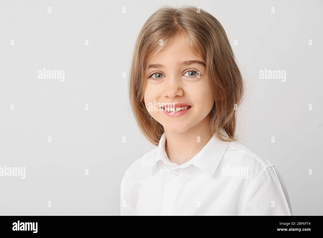 Happy little girl with healthy teeth on light background Stock Photo ...