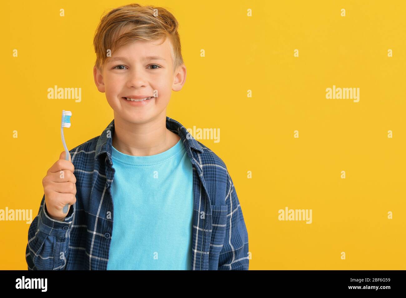 Cute little boy with toothbrush on color background Stock Photo - Alamy