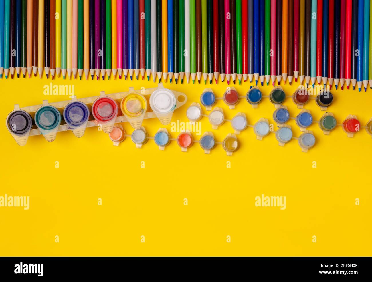 Overhead shot of stationery. Frame of school supplies on yellow paper ...