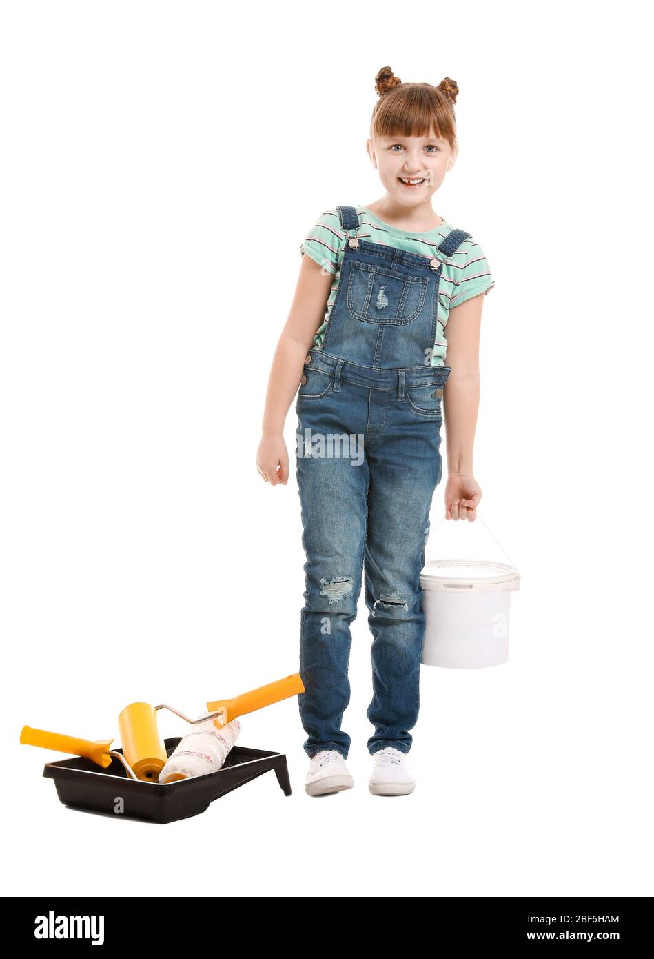 Little girl with paint tools on white background Stock Photo - Alamy