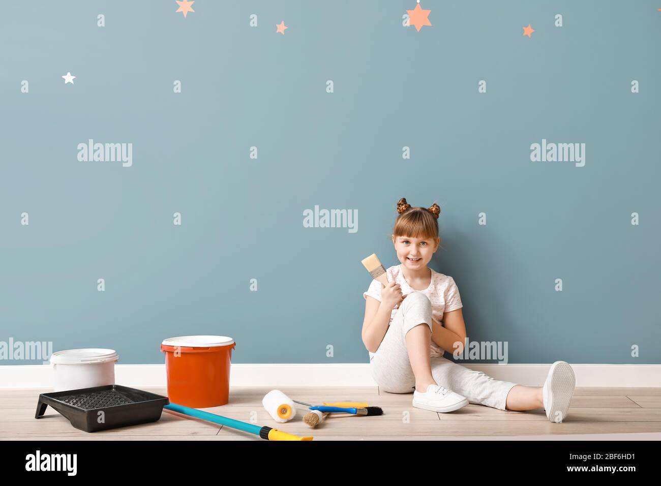 Little girl with painter tools in room Stock Photo - Alamy