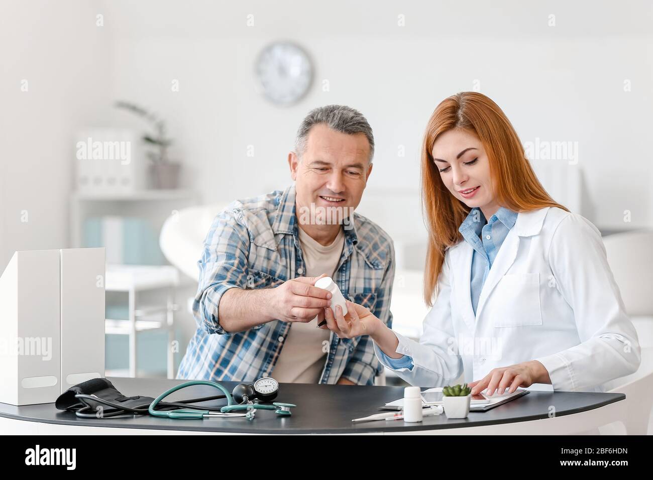 Mature man visiting doctor in clinic Stock Photo - Alamy