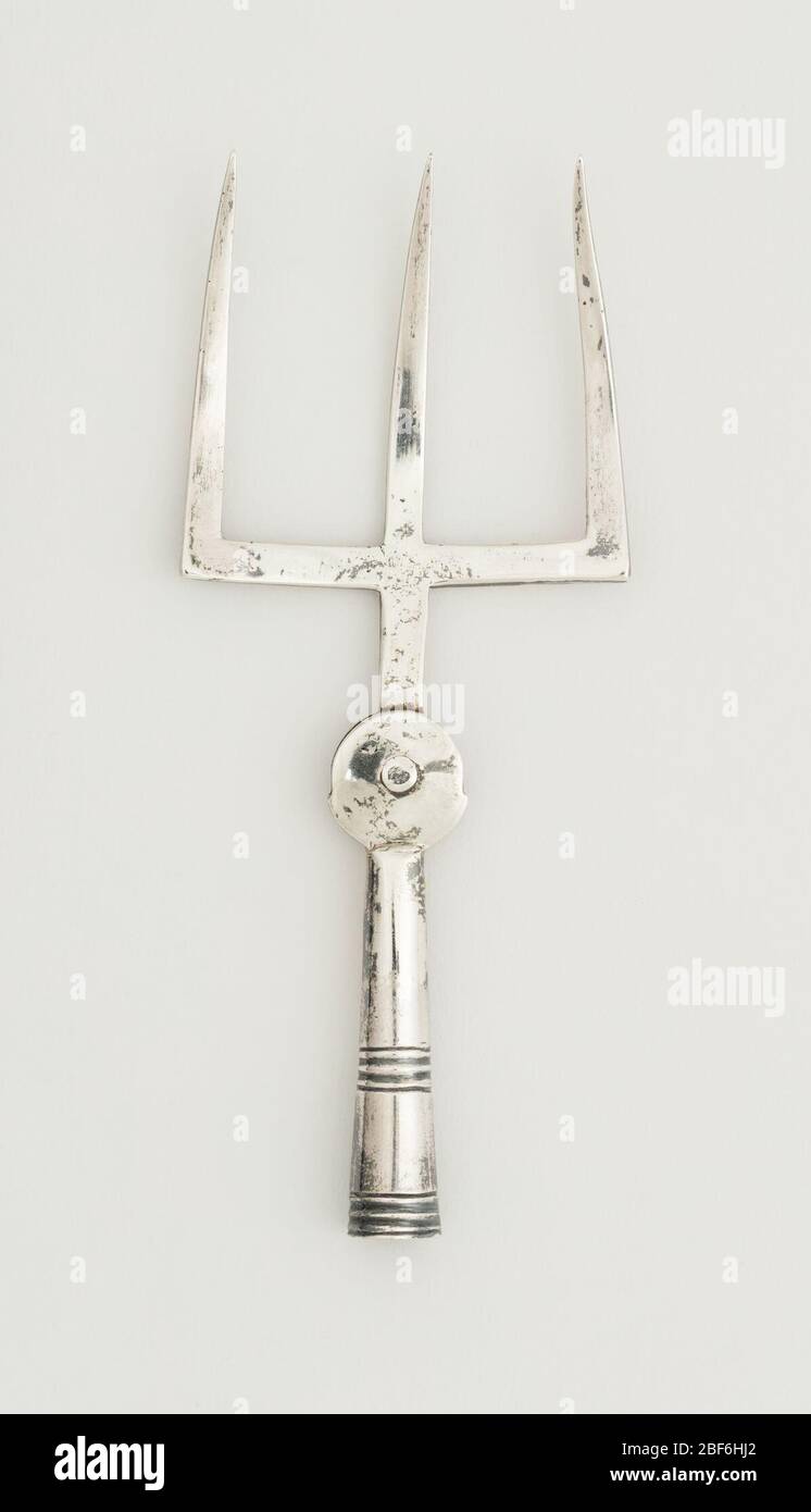 Fork. Three-tine square fork pivots horizontally on a tubular sleeve ...