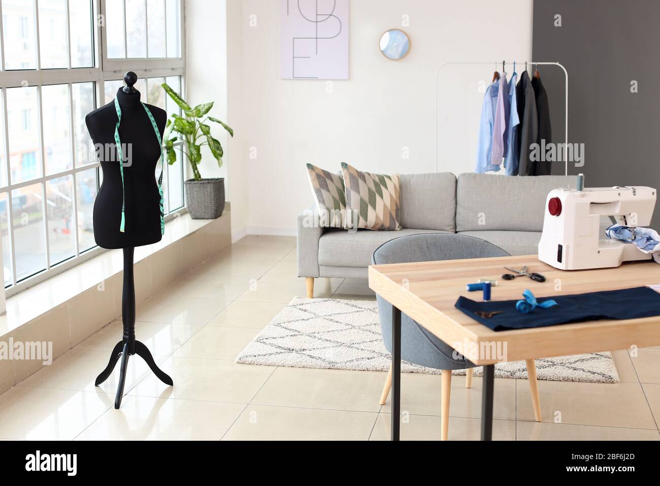 Interior of modern atelier with tailor's workplace Stock Photo - Alamy