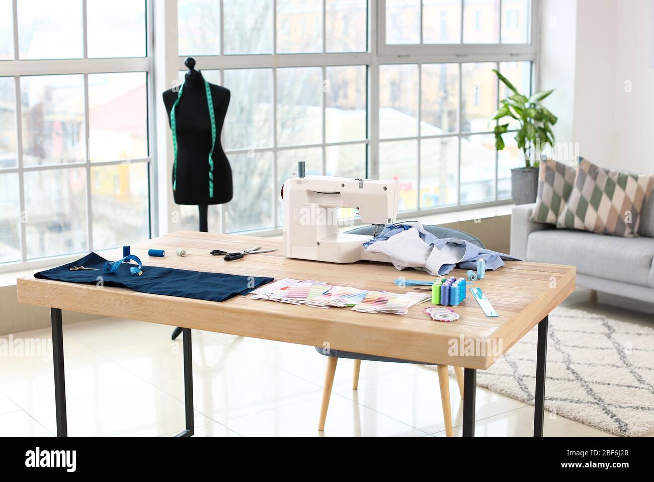 Interior of modern atelier with tailor's workplace Stock Photo - Alamy