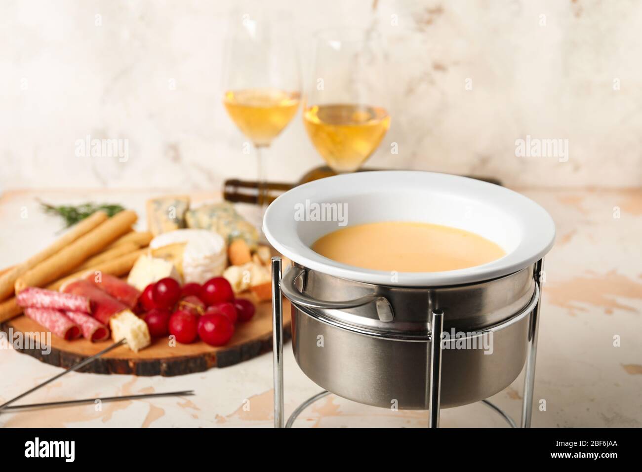 Cheese fondue with snacks on white background Stock Photo - Alamy