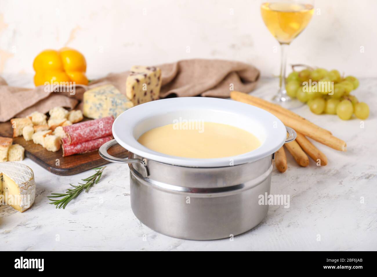 Cheese fondue with snacks on white background Stock Photo - Alamy
