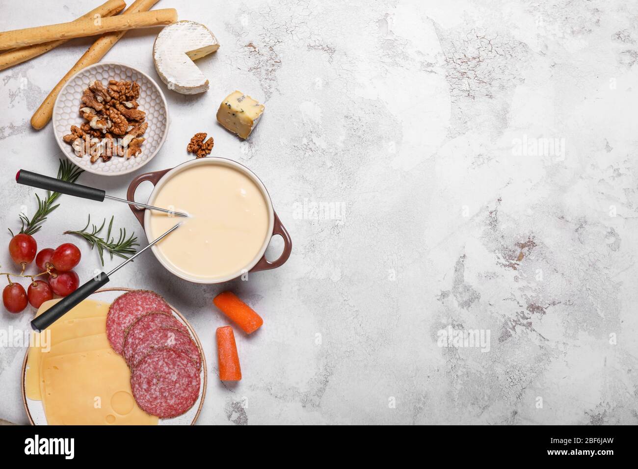 Cheese fondue with snacks on white background Stock Photo - Alamy