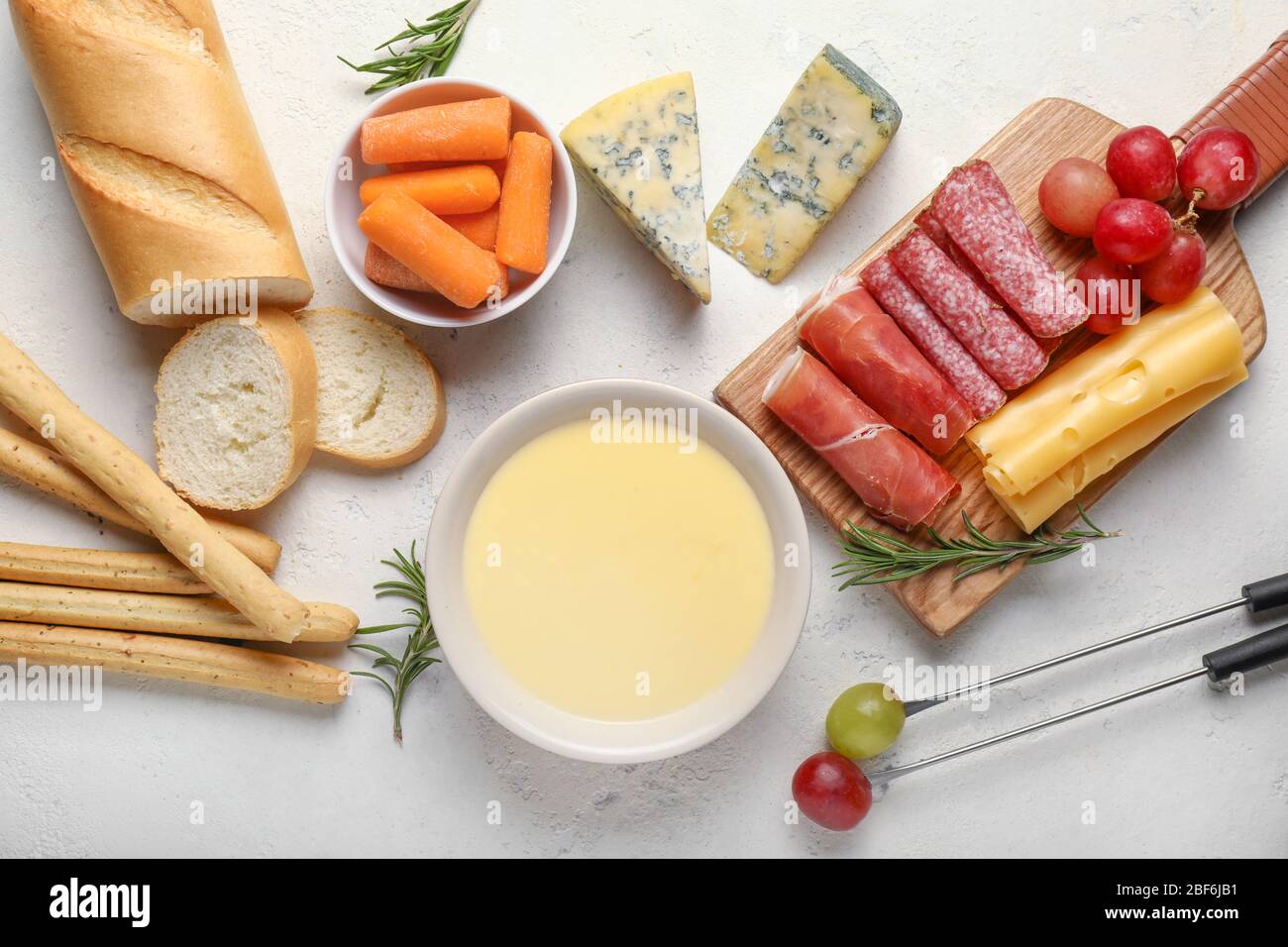 Cheese fondue with snacks on white background Stock Photo - Alamy