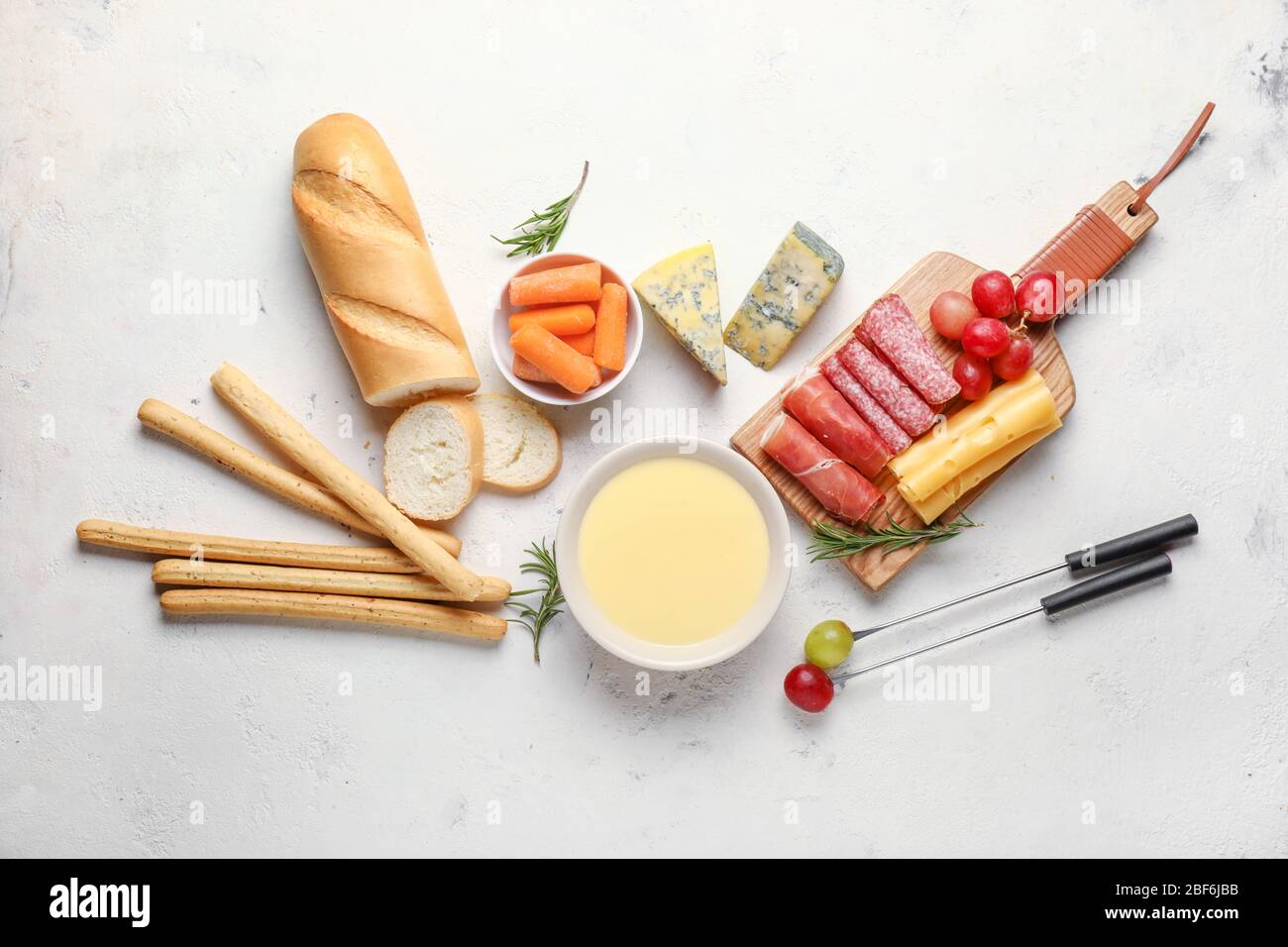 Cheese fondue with snacks on white background Stock Photo - Alamy