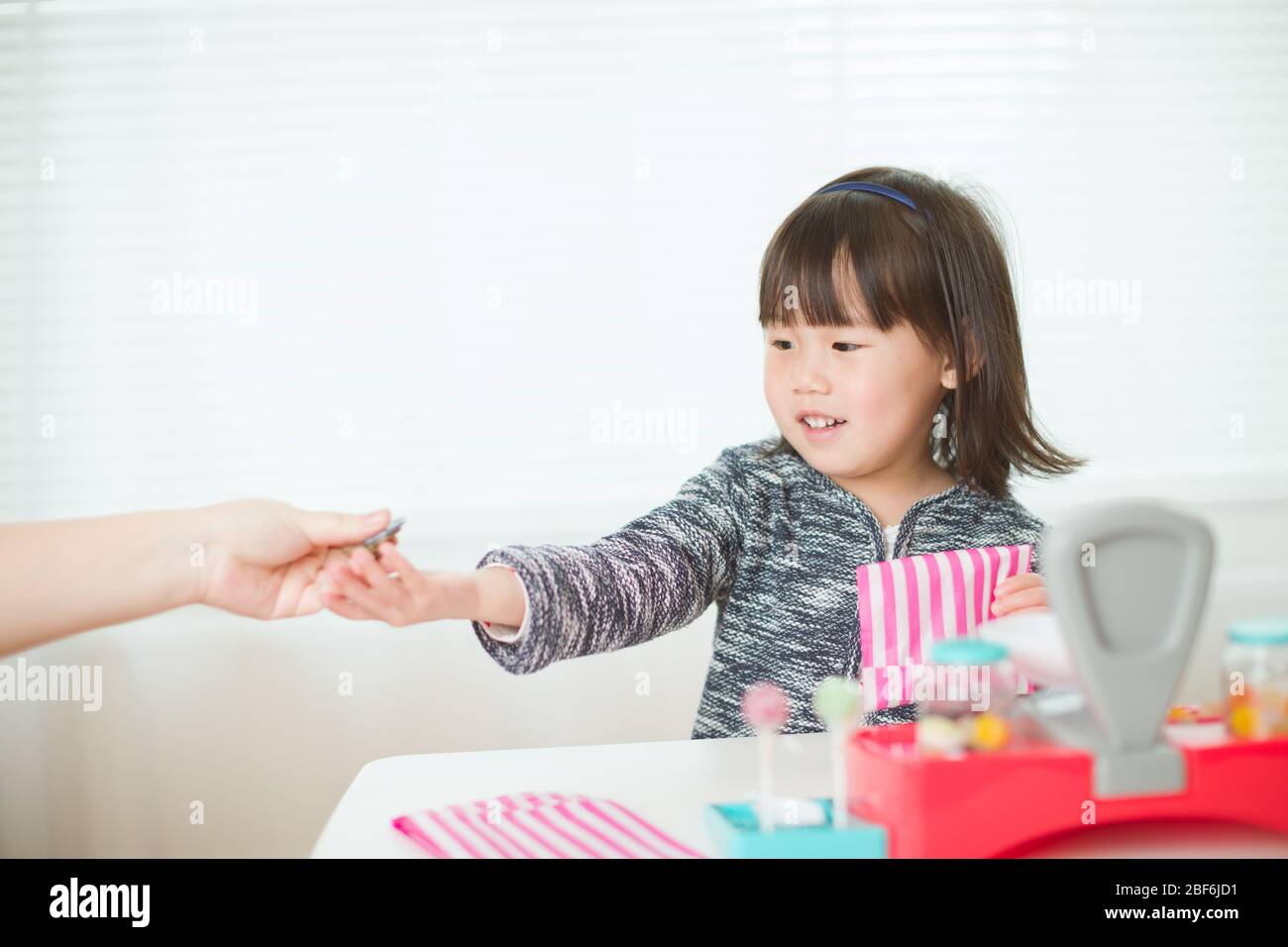 toddler girl pretend play sweet shop keeper at home Stock Photo - Alamy
