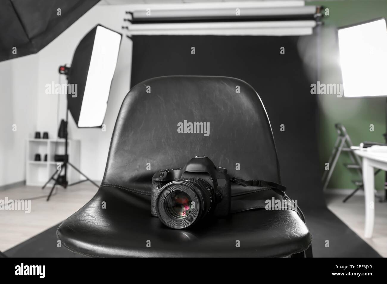 Modern camera on chair in professional photo studio Stock Photo - Alamy
