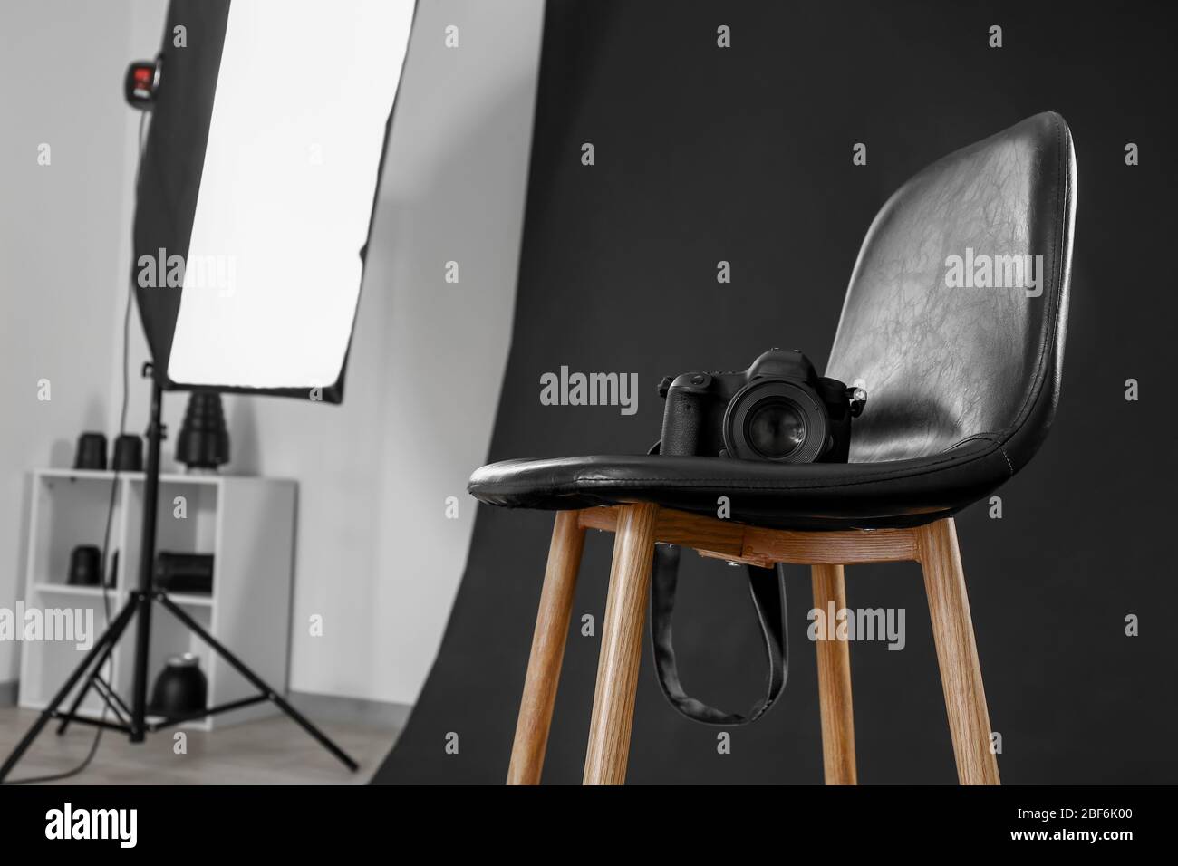Modern camera on chair in professional photo studio Stock Photo - Alamy