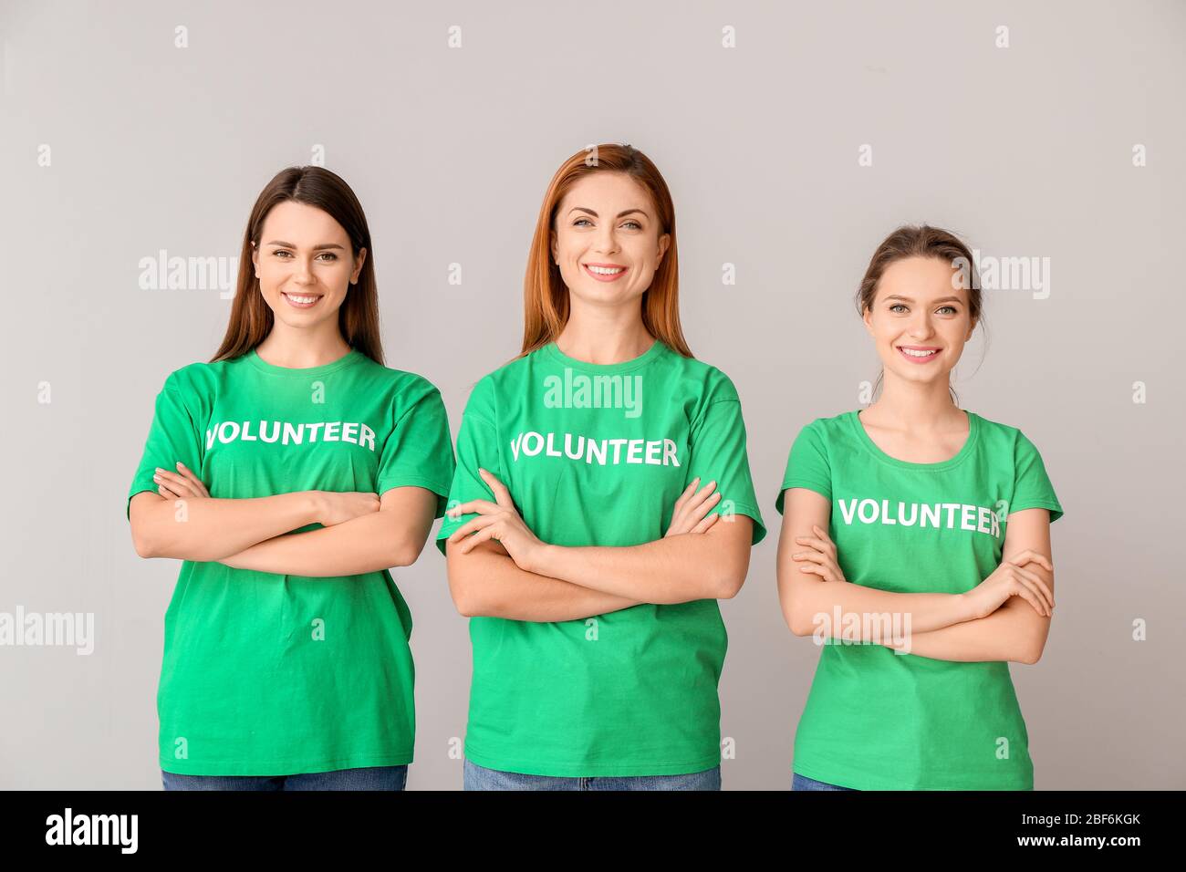 Team of volunteers on light background Stock Photo - Alamy
