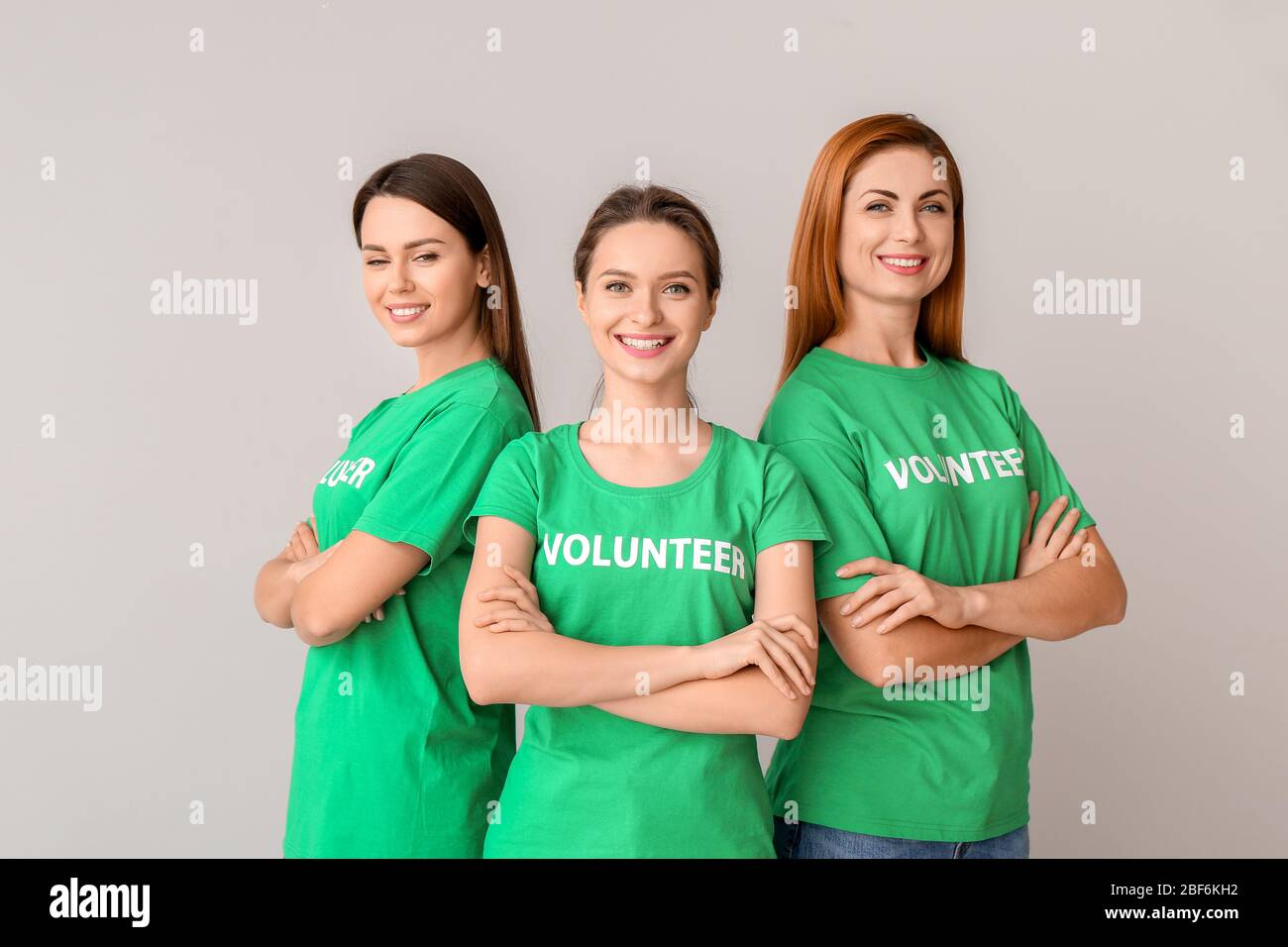 Team of volunteers on light background Stock Photo - Alamy