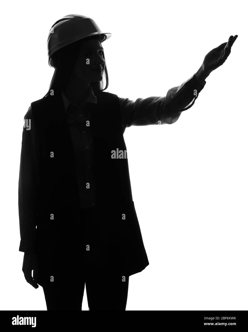 Silhouette of female engineer showing something on white background ...
