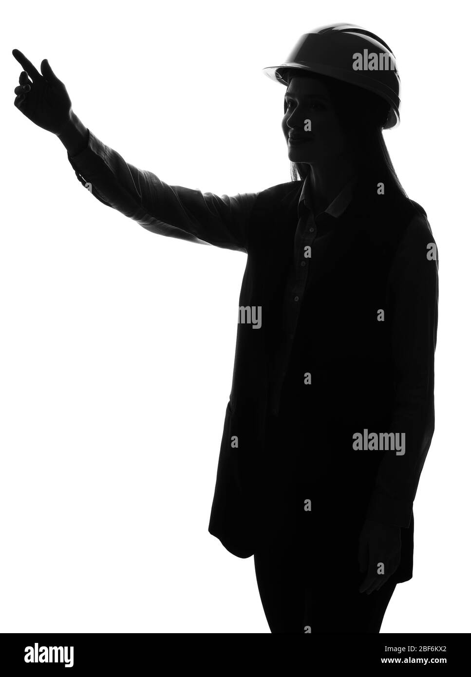 Silhouette of female engineer showing something on white background ...