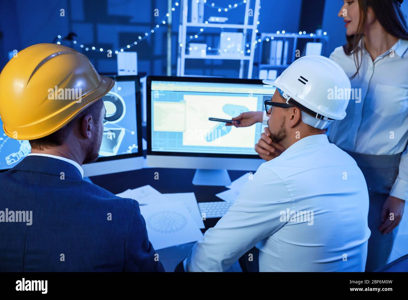 Engineers working in office at night Stock Photo - Alamy