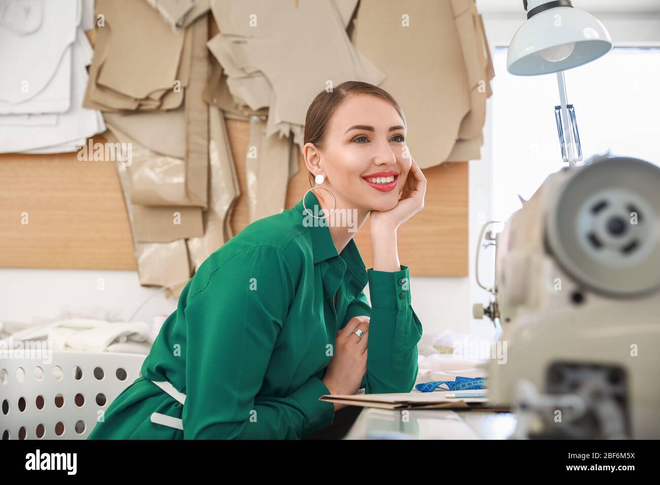 Female tailor working in modern atelier Stock Photo - Alamy