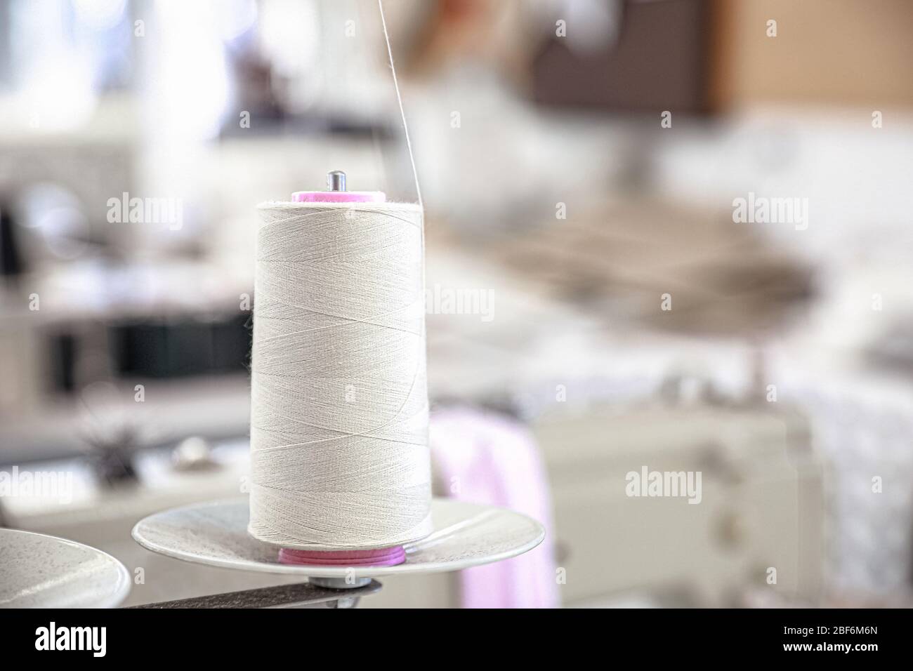 Spool of threads in tailor workshop, closeup Stock Photo - Alamy