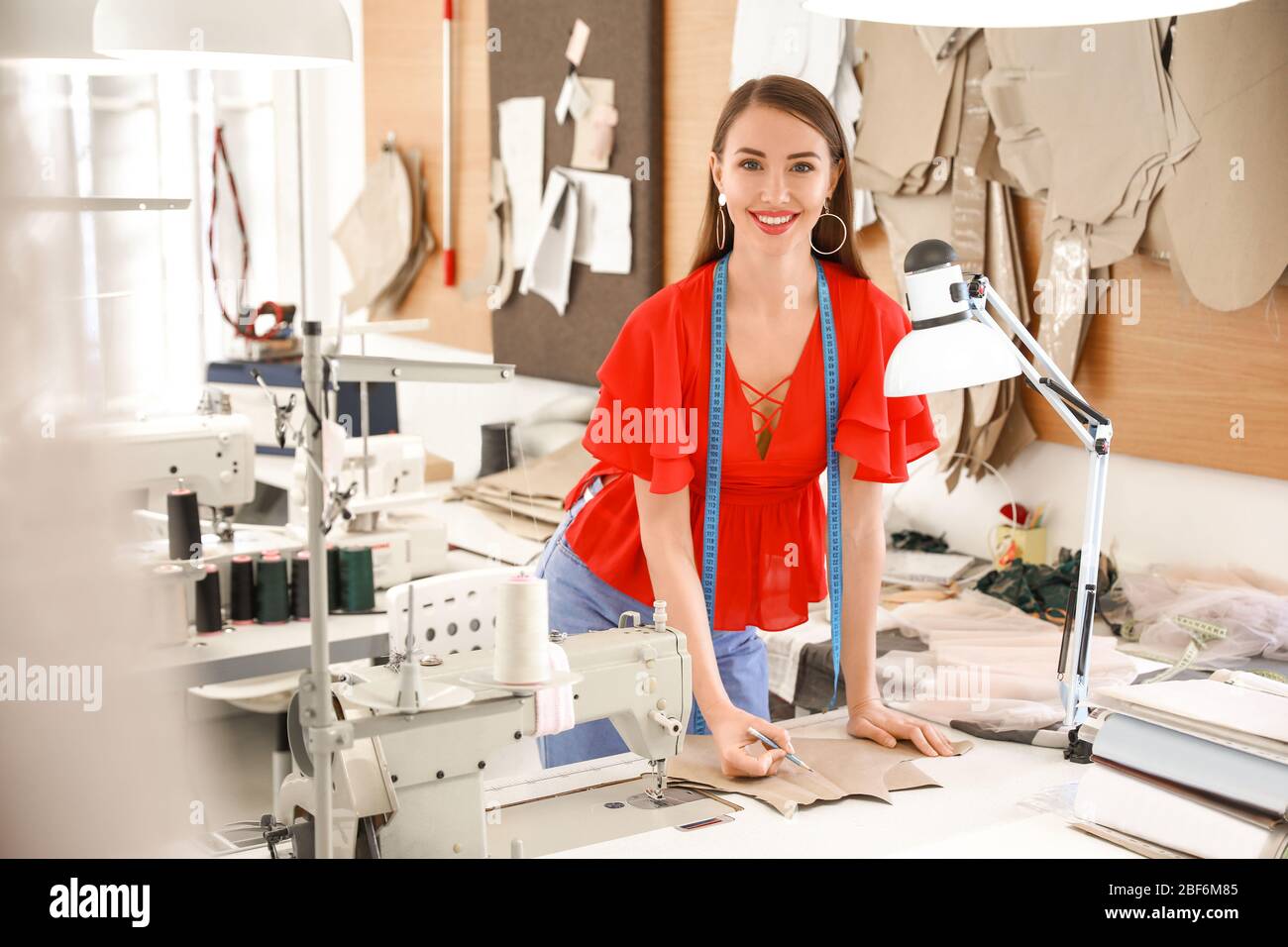 Female tailor working in modern atelier Stock Photo - Alamy