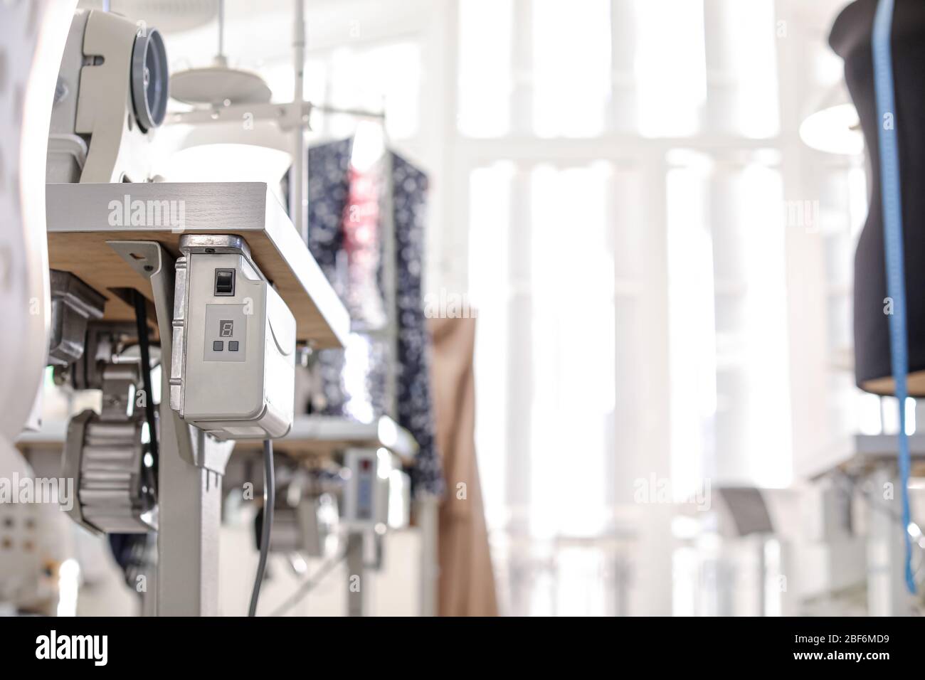Modern sewing equipment in tailor workshop Stock Photo - Alamy