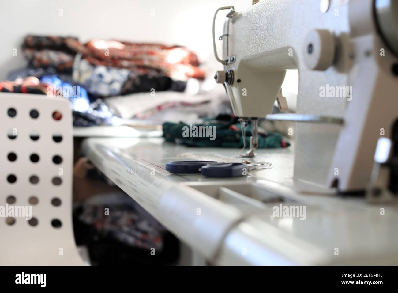 Modern sewing equipment in tailor workshop Stock Photo - Alamy