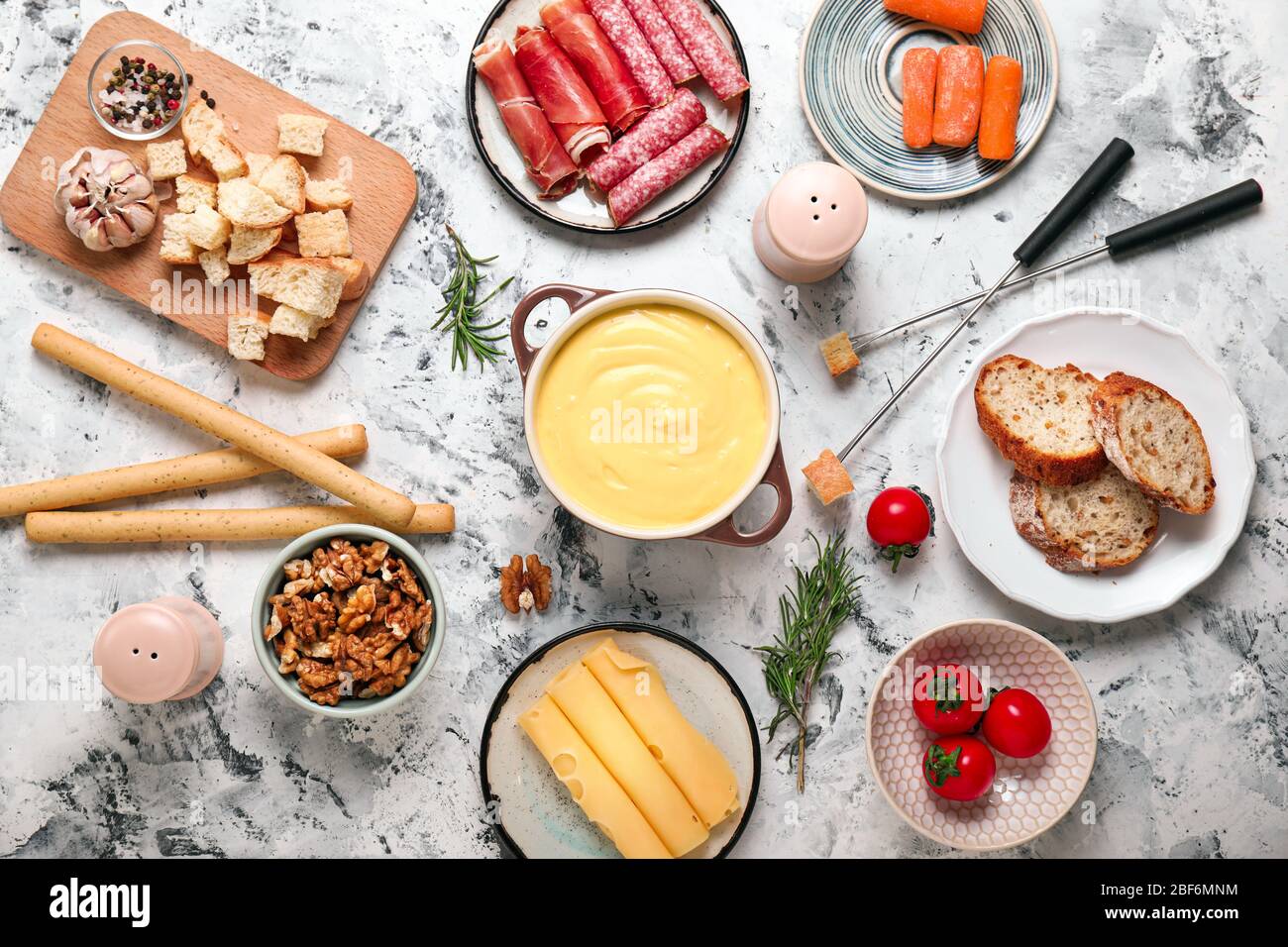 Cheese fondue with snacks on white background Stock Photo - Alamy
