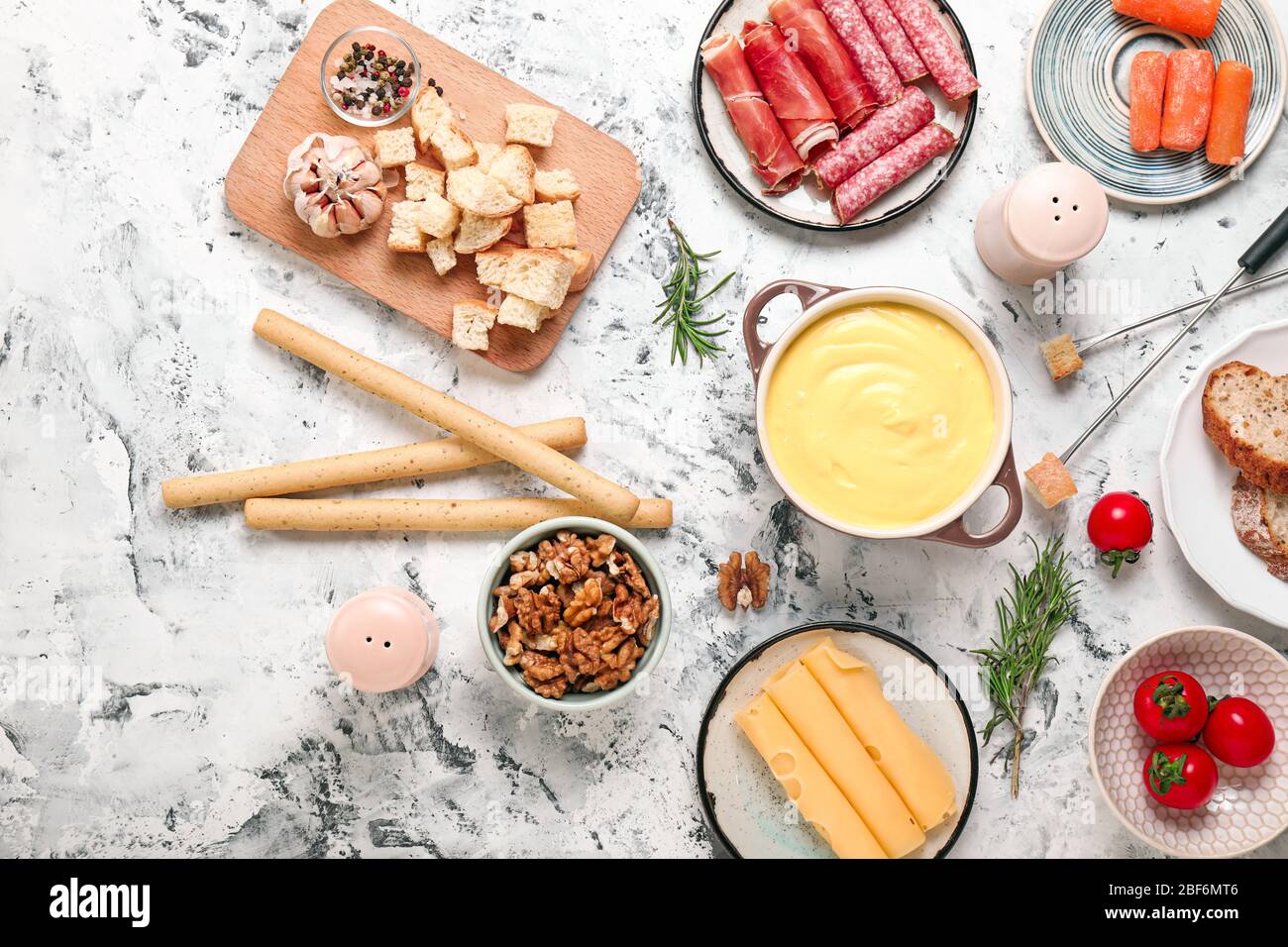 Cheese fondue with snacks on white background Stock Photo - Alamy