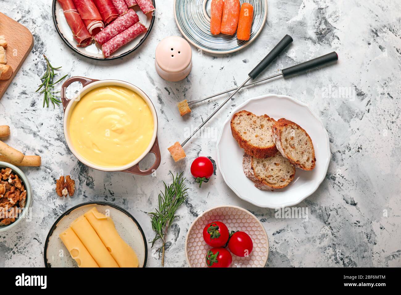 Cheese fondue with snacks on white background Stock Photo - Alamy