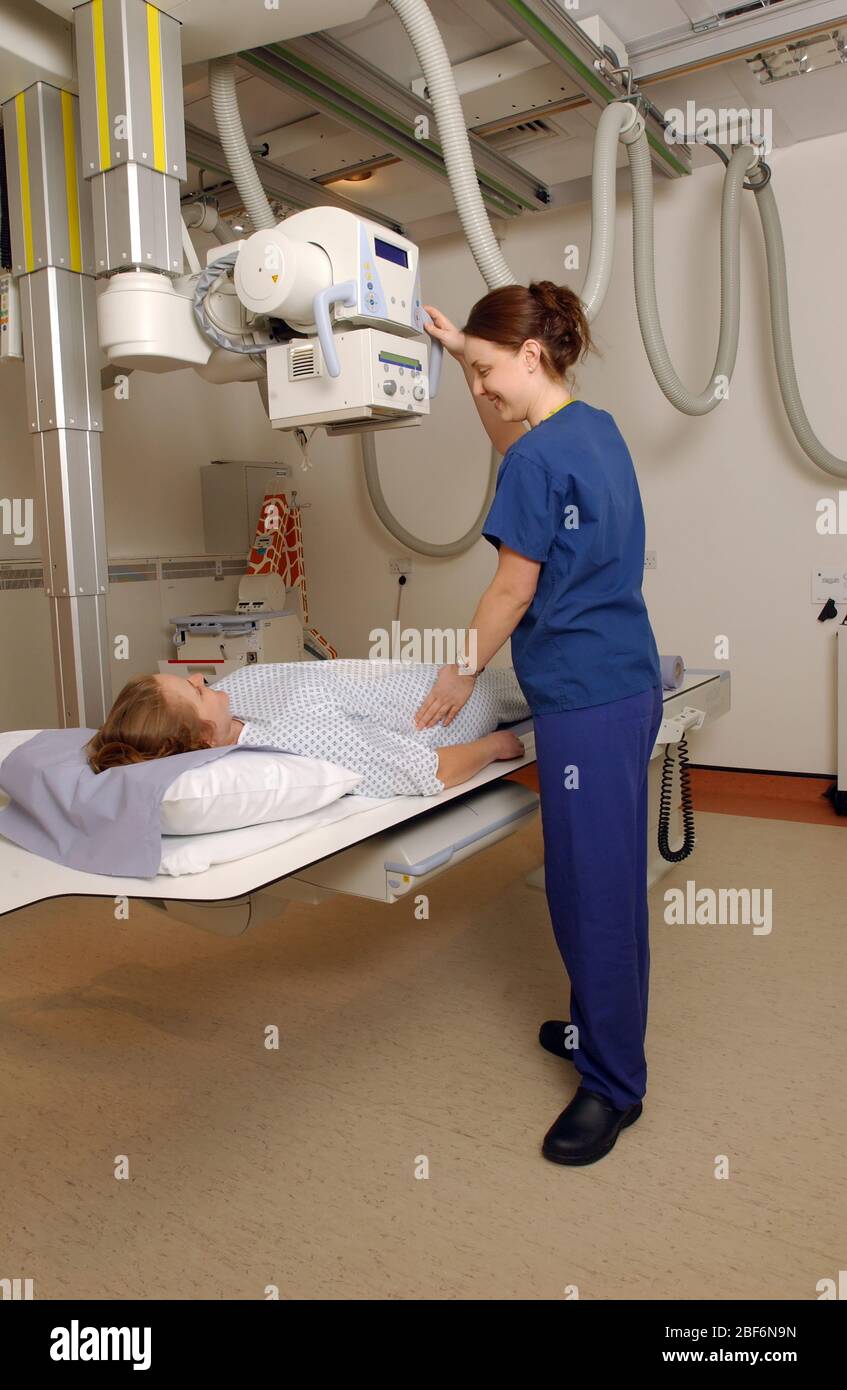 A radiologist Sets up the imaging control unit aiming the light on the ...