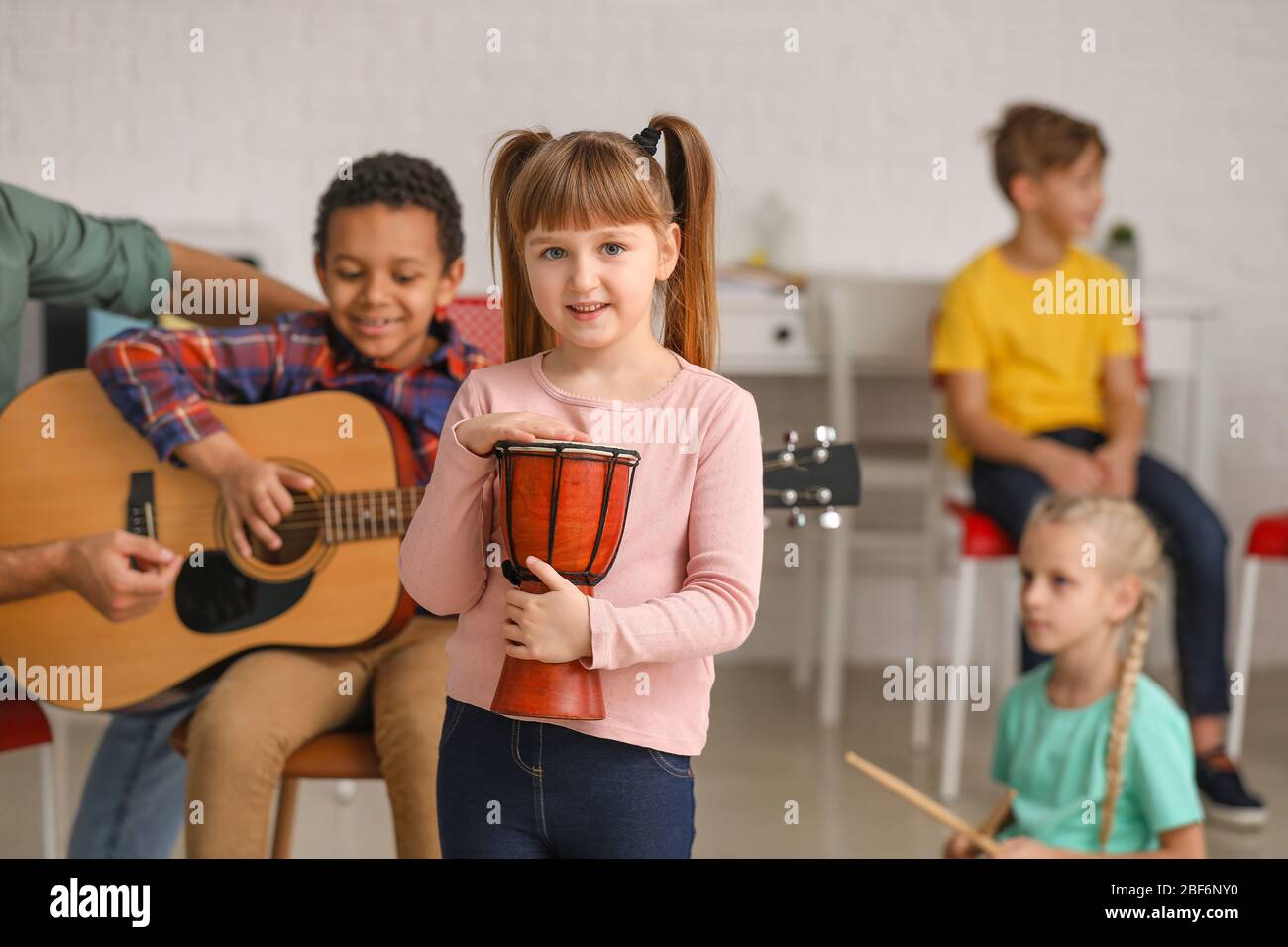Cute little girl at music school Stock Photo - Alamy